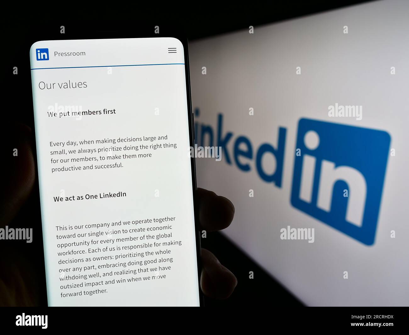 Person holding smartphone with web page of US social media company ...