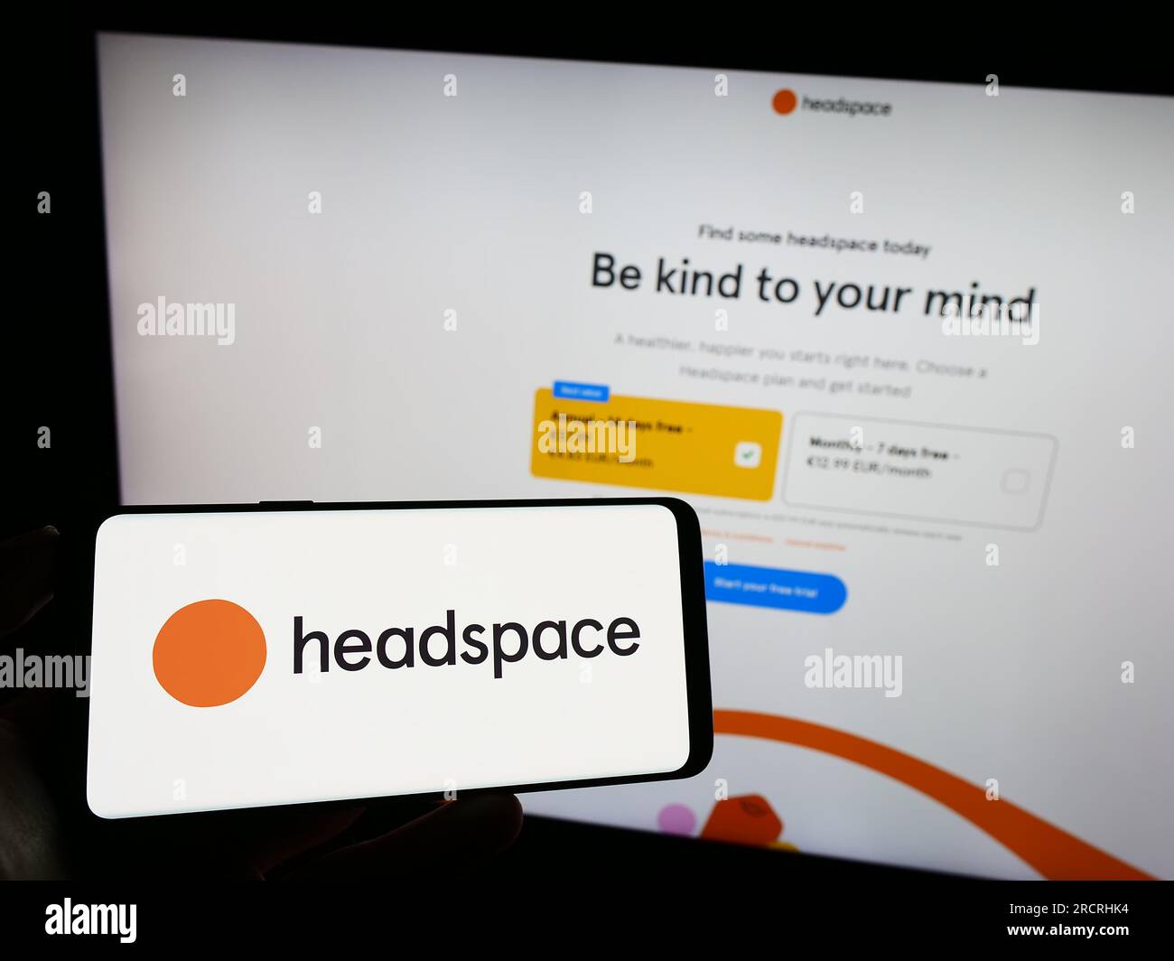 Person holding mobile phone with logo of mediation company Headspace ...