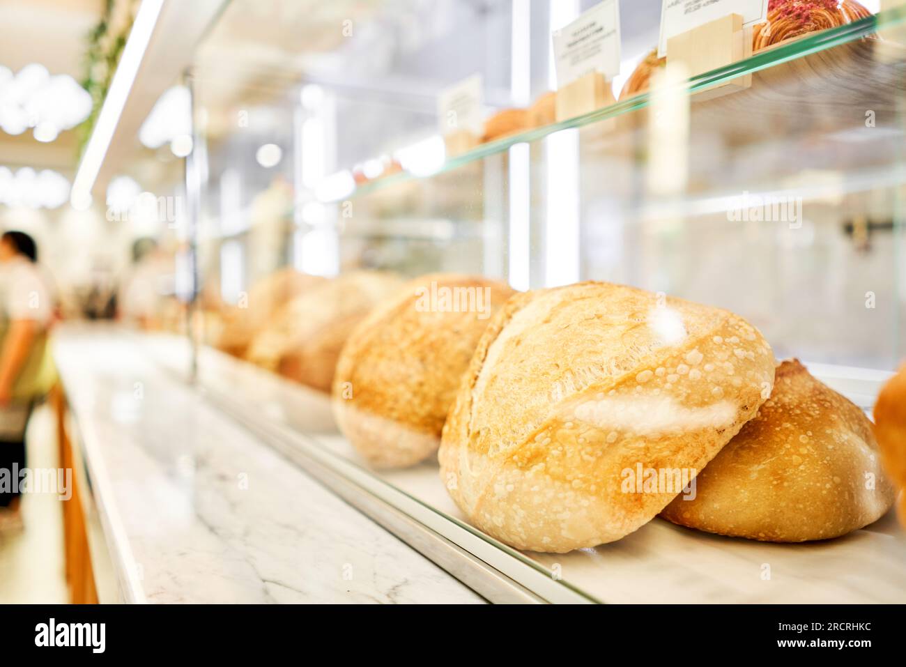 Different kinds of bread on the counter in the bakery shop. Fresh bread ...
