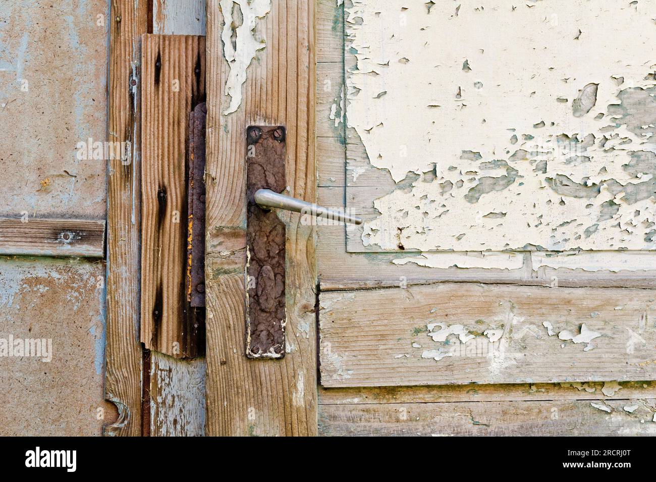 Old metal handle on ancient door with cracked white paint Stock Photo ...