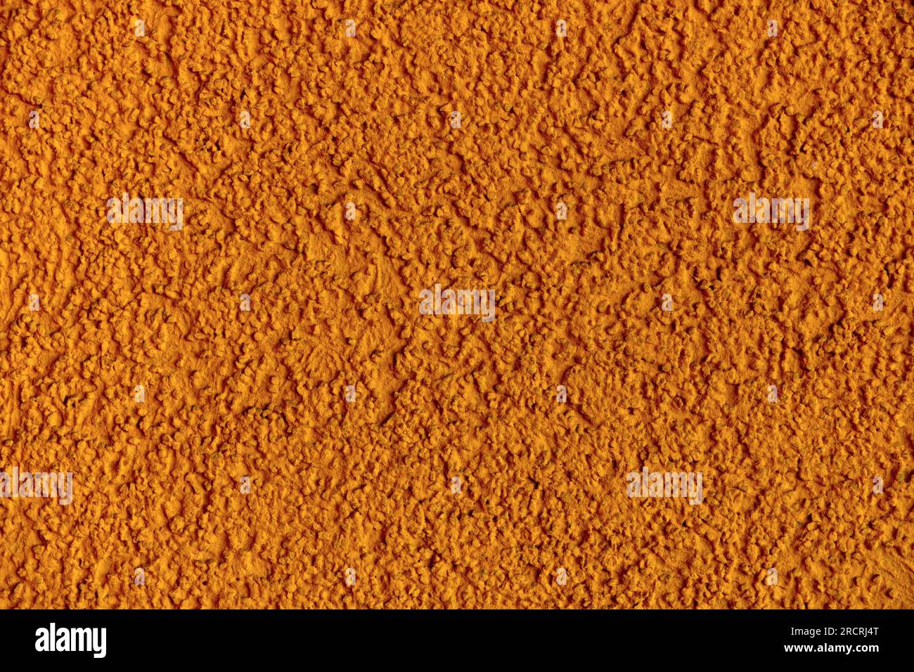Texture of the orange insulated wall with a rough cast plaster finish ...