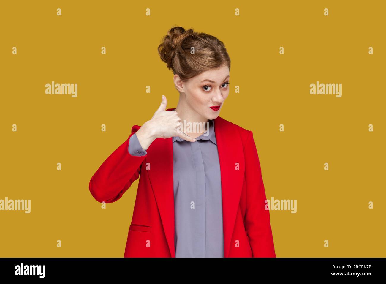 Portrait of flirting positive woman with red lips standing showing call ...