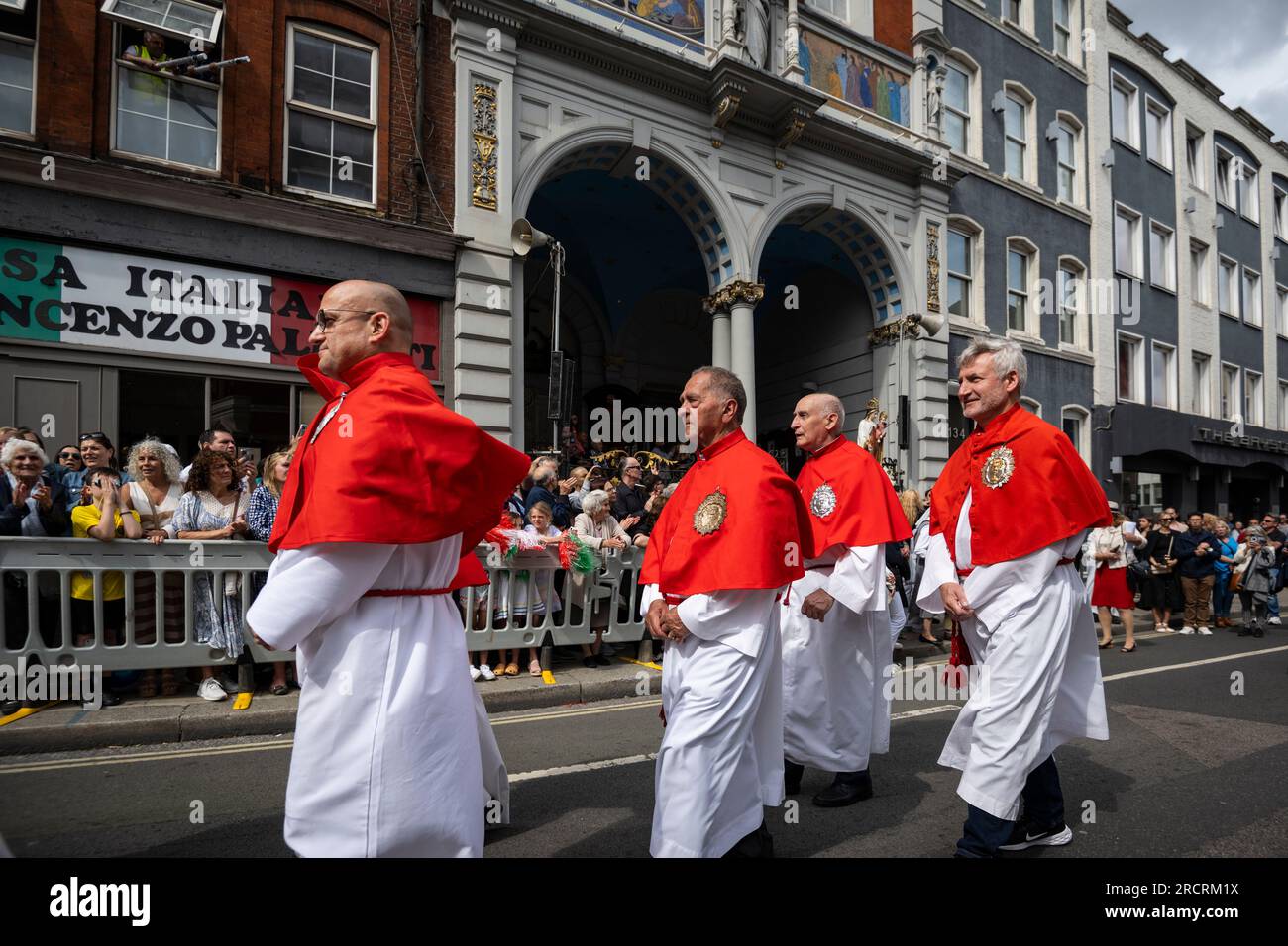 London, UK. 16 July 2023. Priests passing St Peter's Italian Church ...