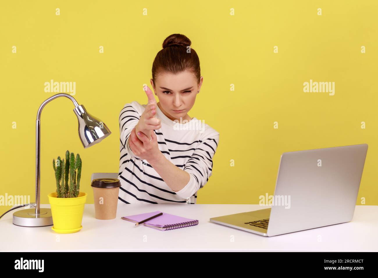 Angry woman office worker sitting at workplace with laptop threatening ...