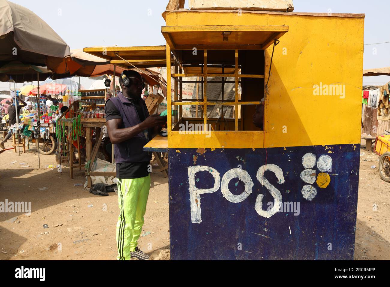 A man stands outside a POS kiosk in Mpapa, Abuja, Nigeria Stock Photo ...