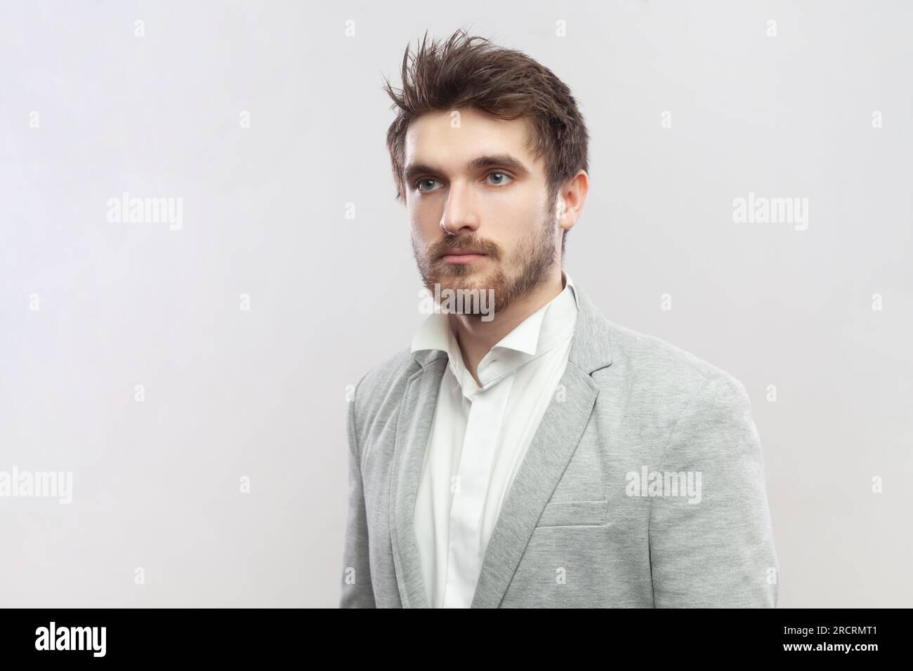 Portrait of handsome attractive young bearded man standing with serious ...