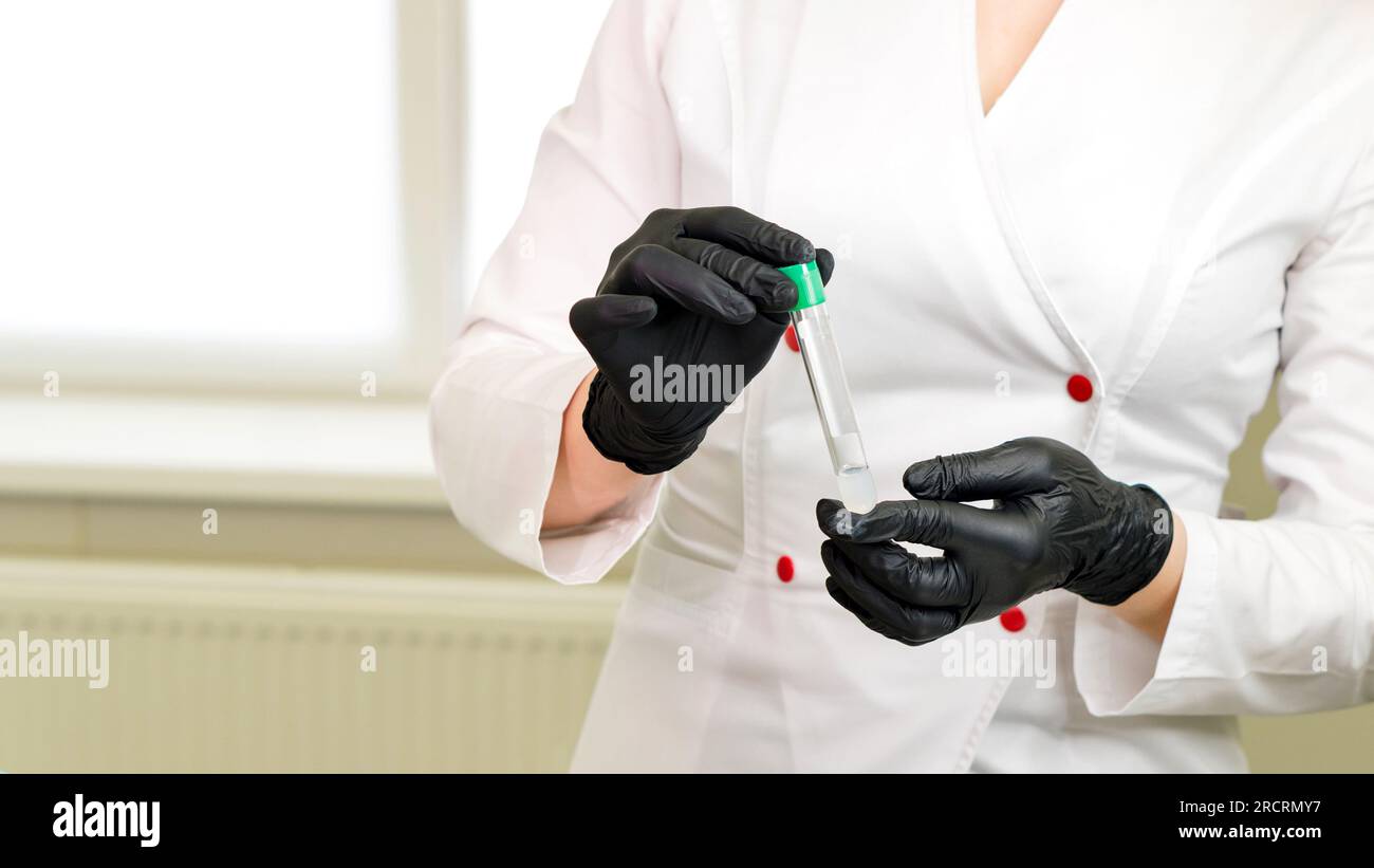 Nurse hand in medical glove holding test-tube to take blood analysis ...