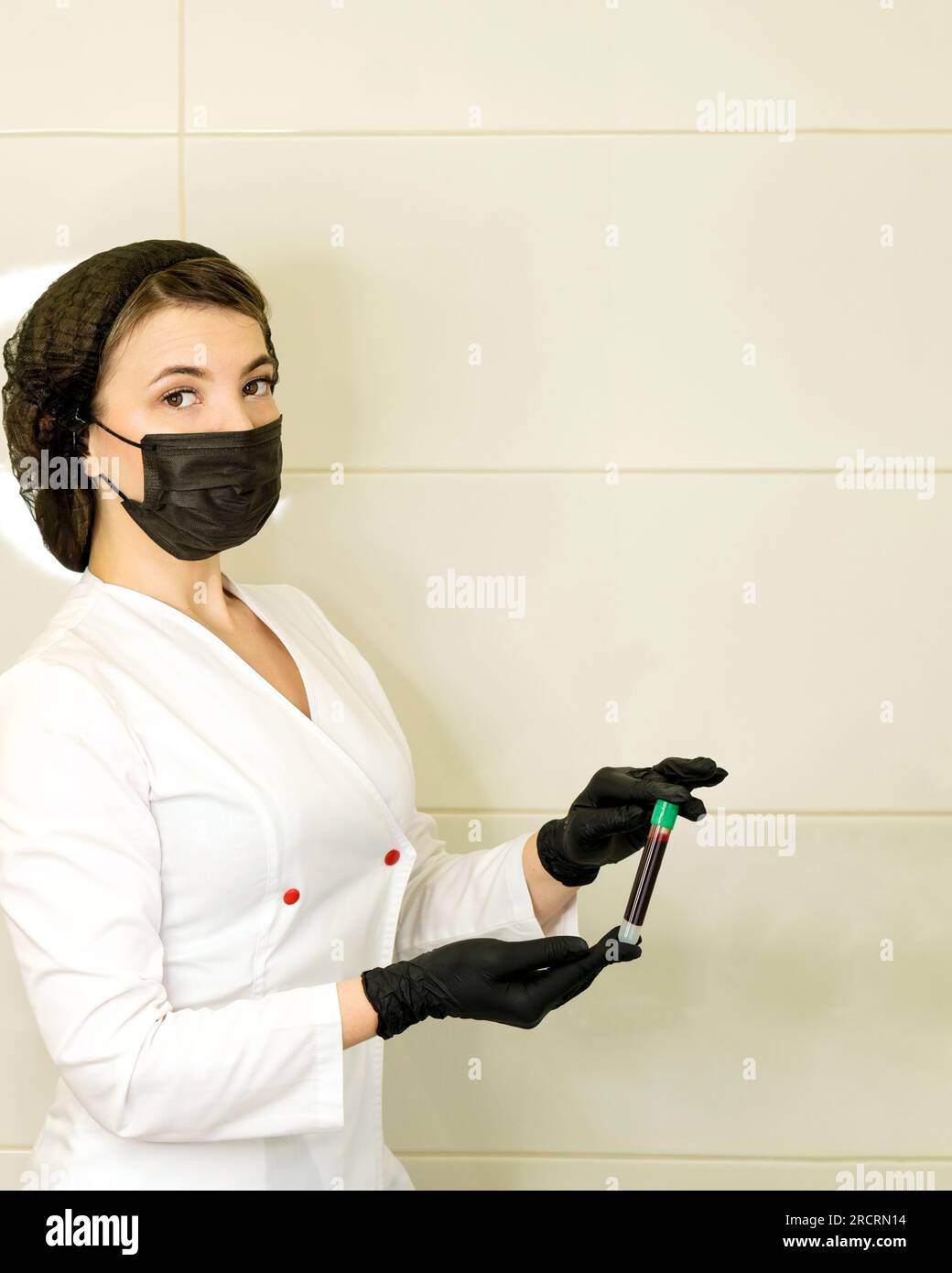 Сosmetologist holds test tube with blood in front of centrifuge. Stage ...