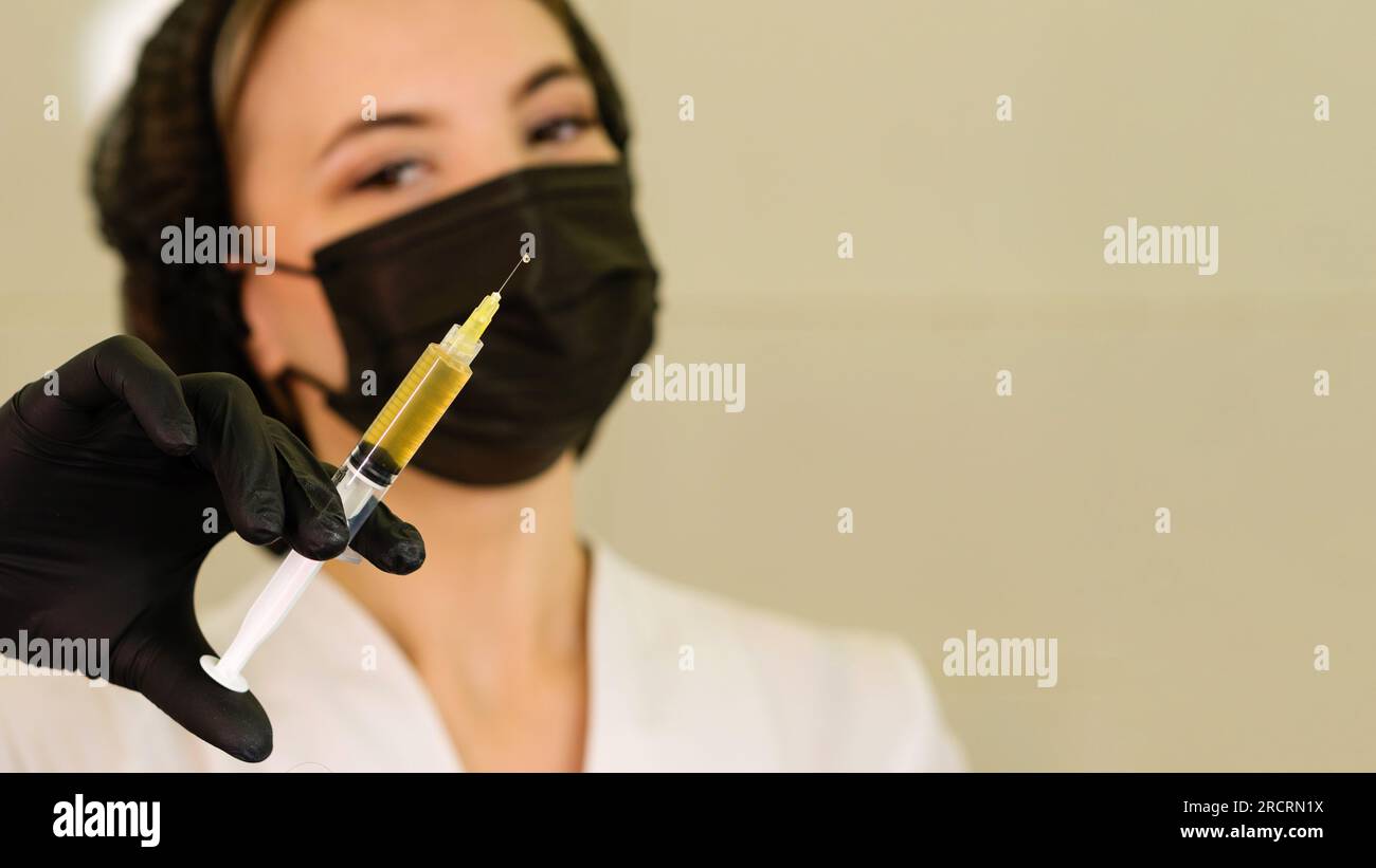 Syringe in beautician's hand for PRP therapy with blood platelet rich ...