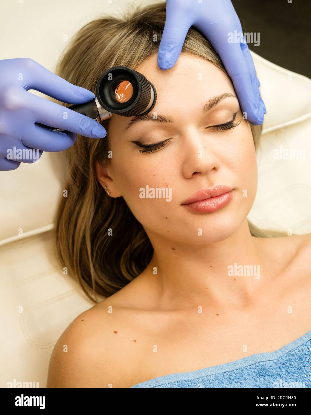 Doctor Dermatologist Examines Moles And Birthmarks Of Female Patient