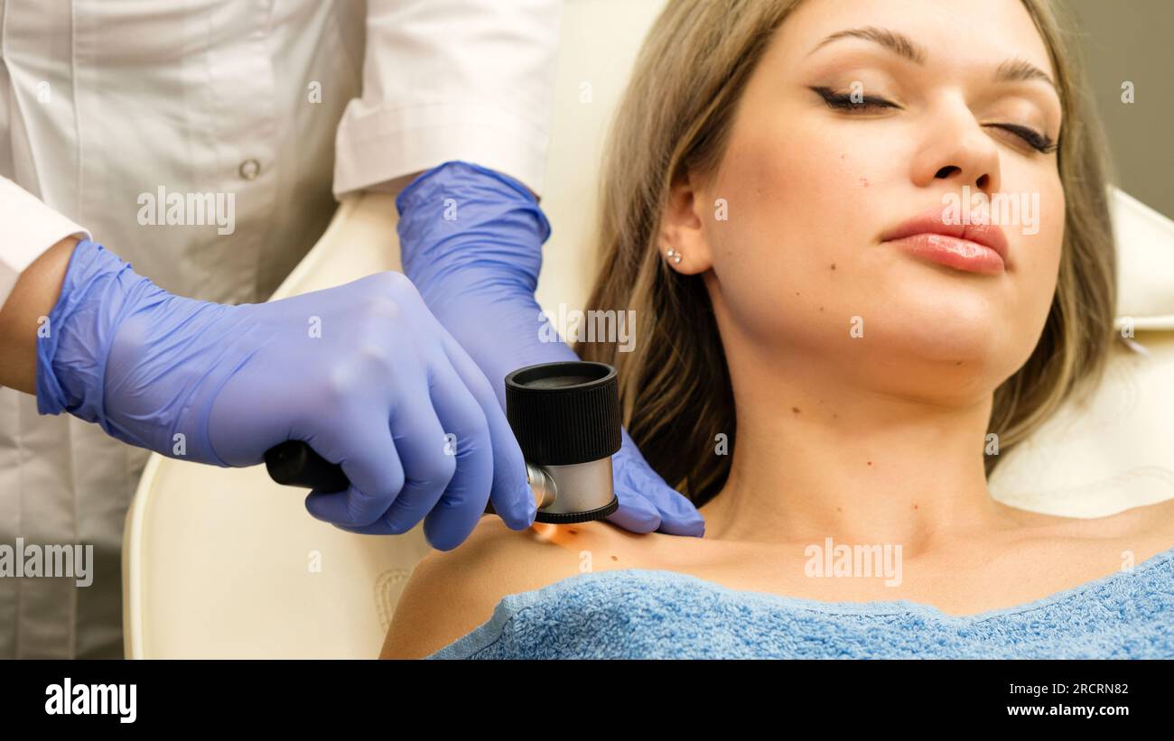 Doctor Dermatologist Examines Moles And Birthmarks Of Female Patient