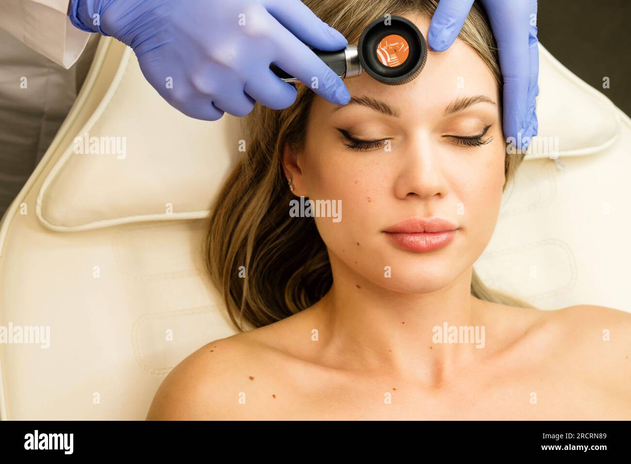 Doctor Dermatologist Examines Moles And Birthmarks Of Female Patient