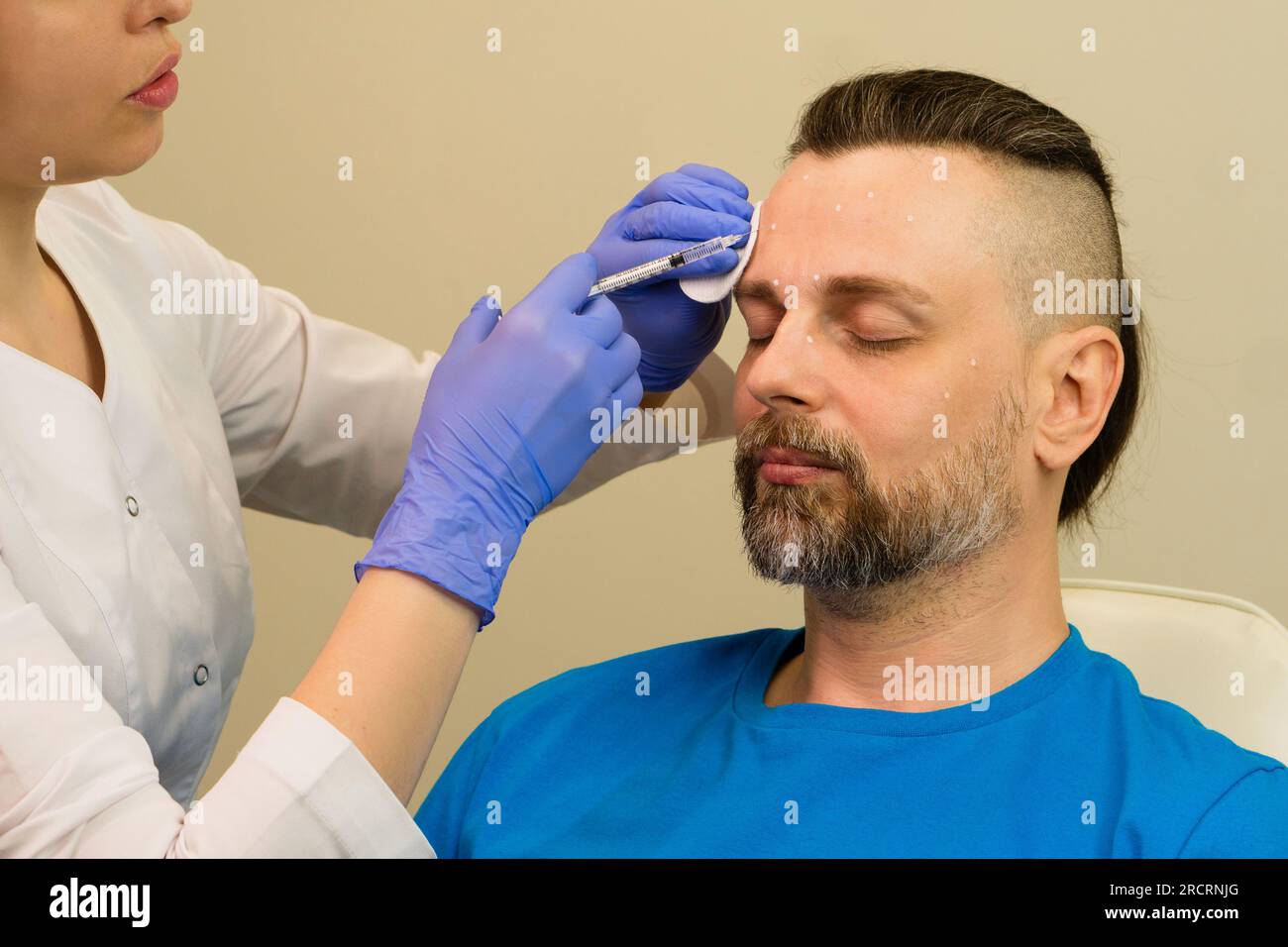 Beautician making botulinum toxin injections to male patient. Beauty ...