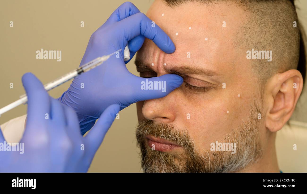 Esthetician making botulinum toxin injections to male patient. Beauty ...