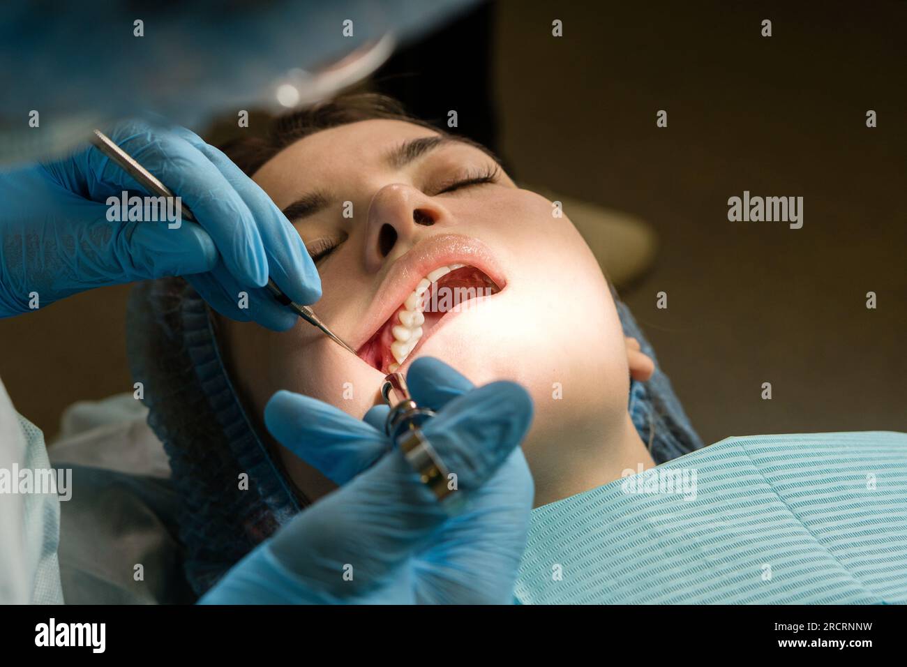 Dental surgeon performs conduction anesthesia with lidocaine using a ...