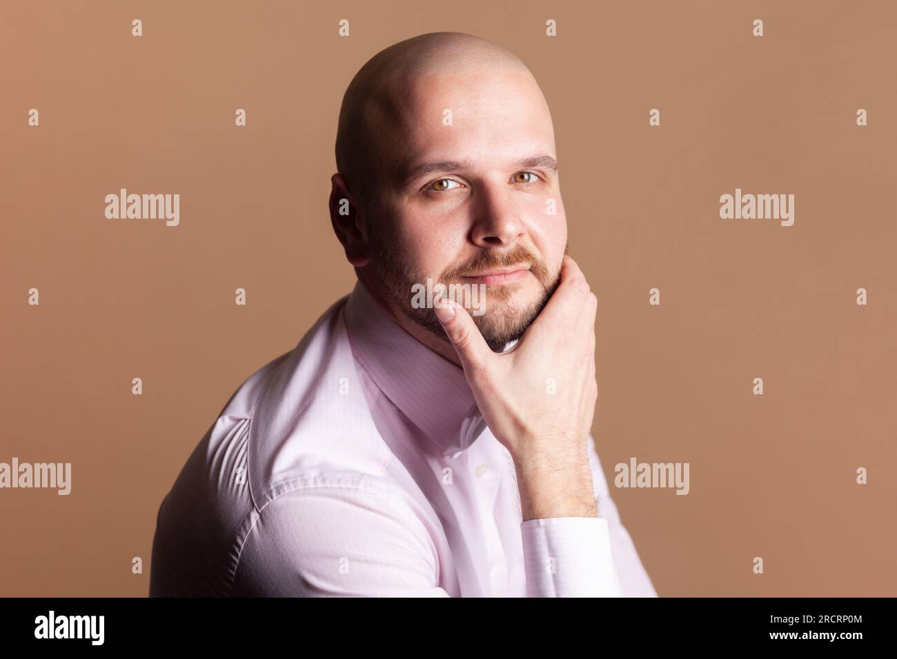Side View Portrait Of Cute Positive Smiling Bald Bearded Man Sitting