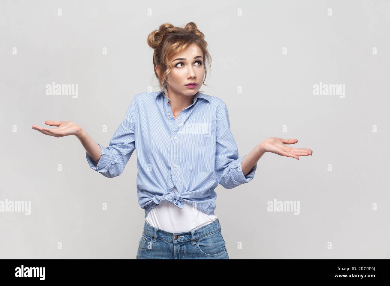 Who knows. Clueless hesitant beautiful blonde woman spreads palms ...