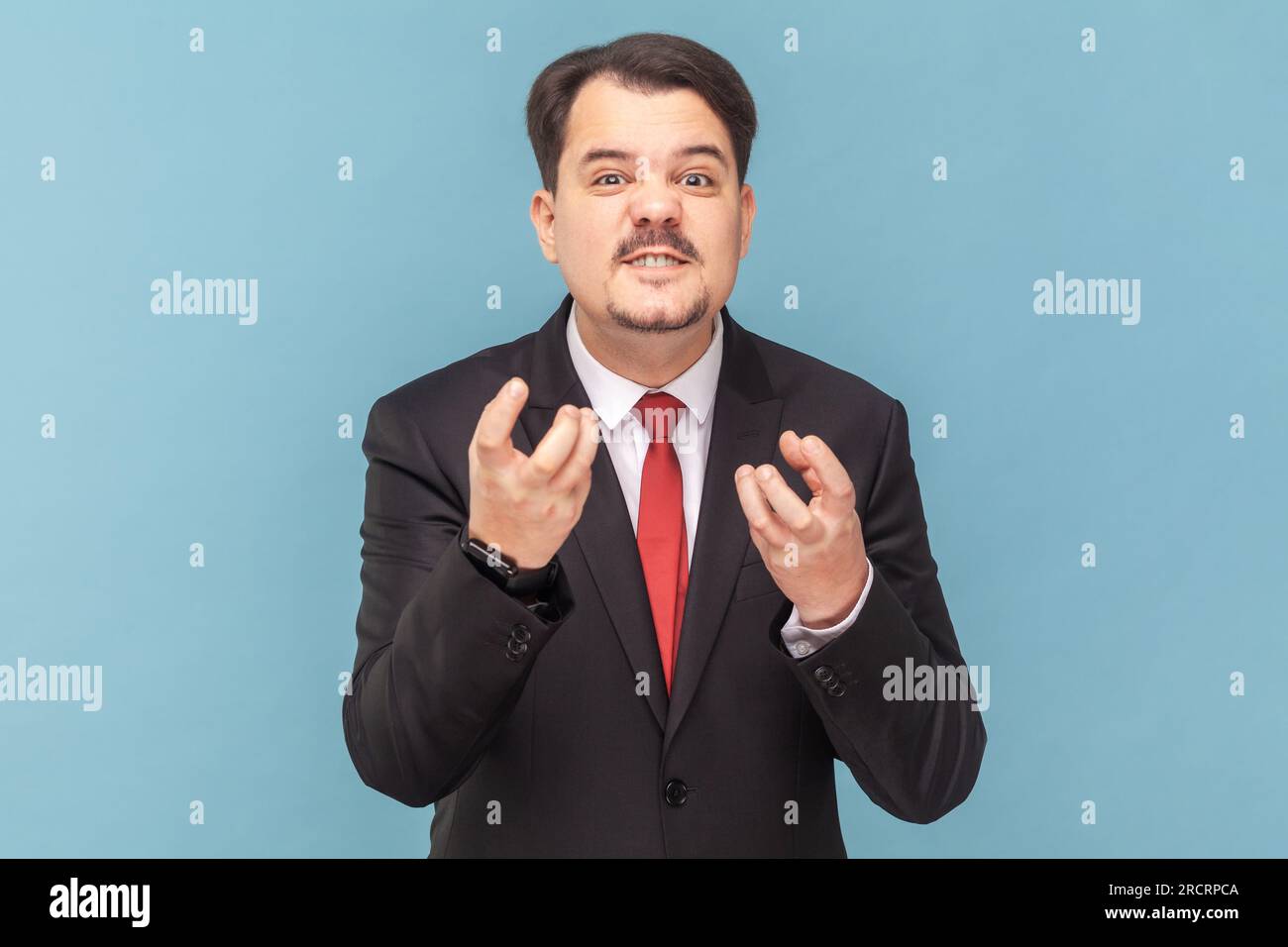 Portrait of angry aggressive man with mustache standing with raised ...