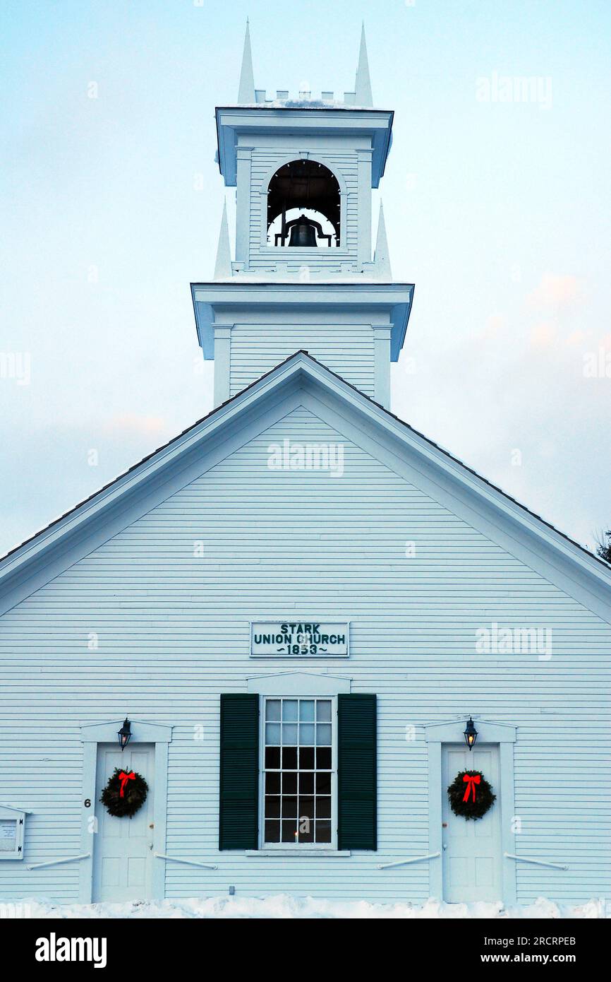 A small country church is decorated with Christmas wreaths during the ...