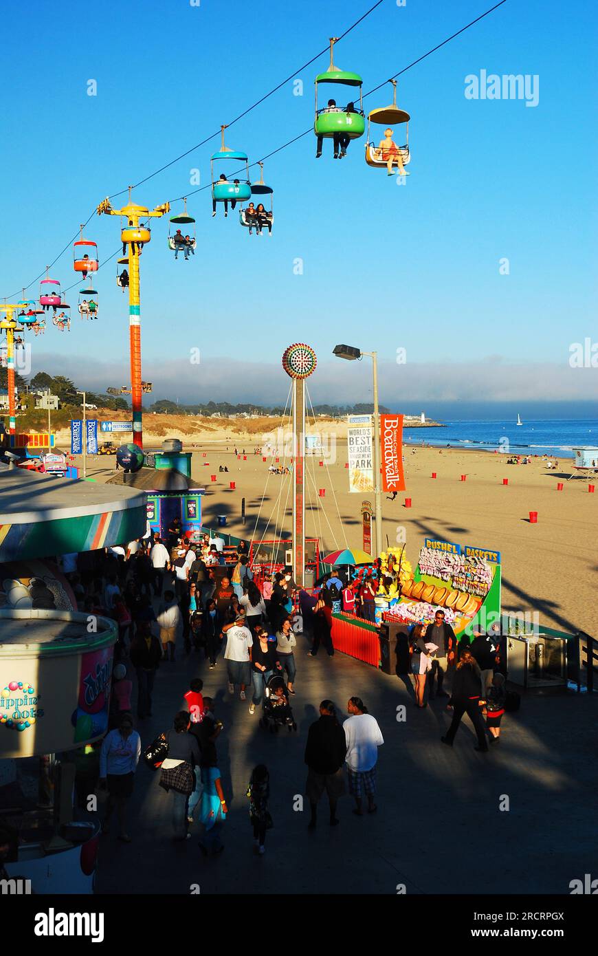 The sky glider soars over the people walking along the Santa Cruz ...