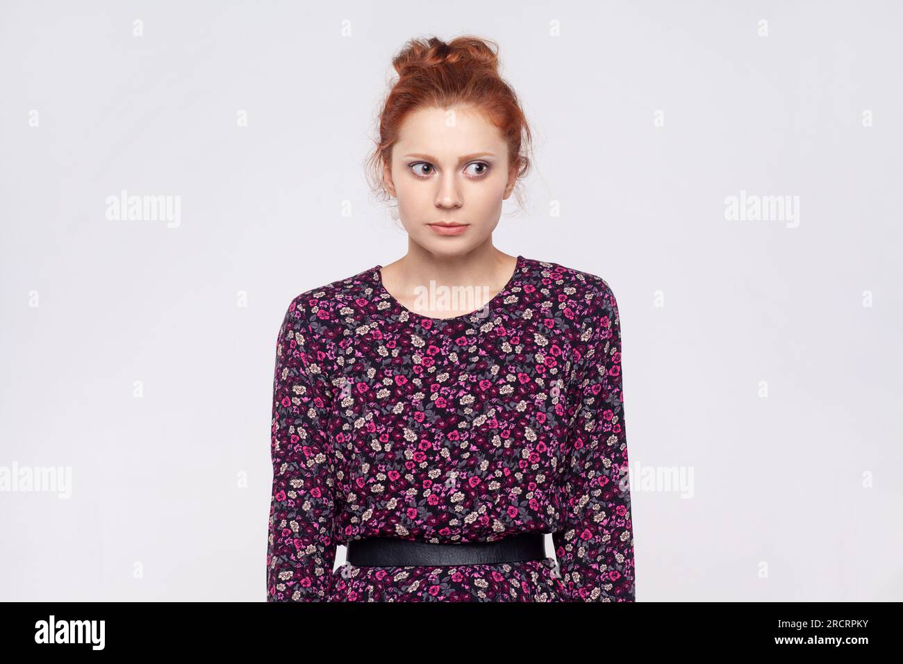 Portrait of worried serious young adult attractive ginger woman wearing ...