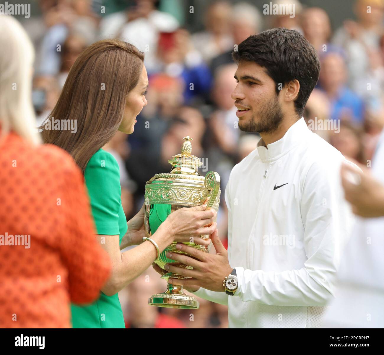 Carlos Alcaraz of Spain receives a victory trophy from Catherine ...