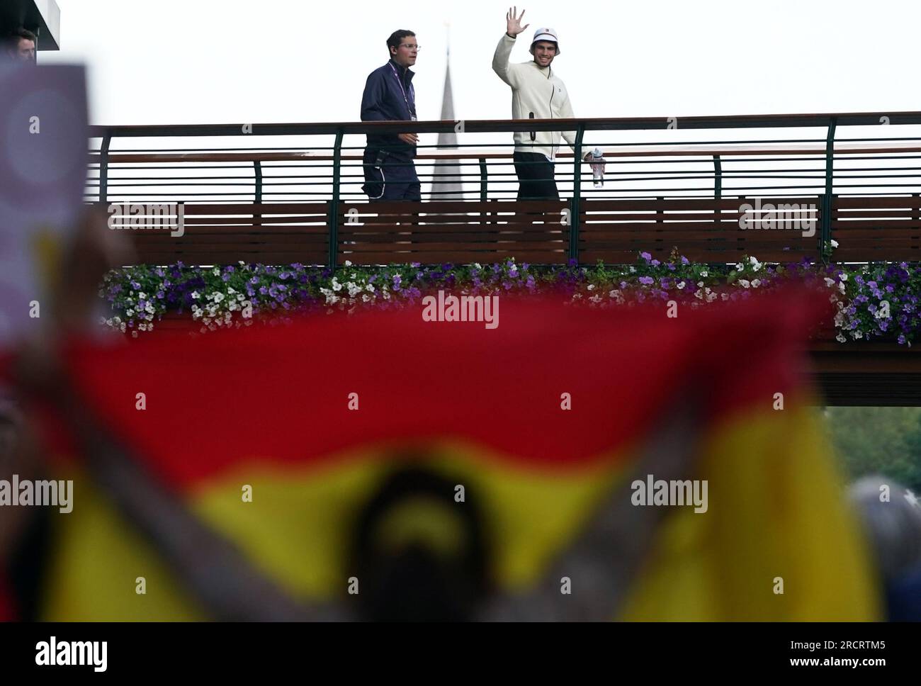 Carlos Alcaraz acknowledges the crowd as he walks across the players ...