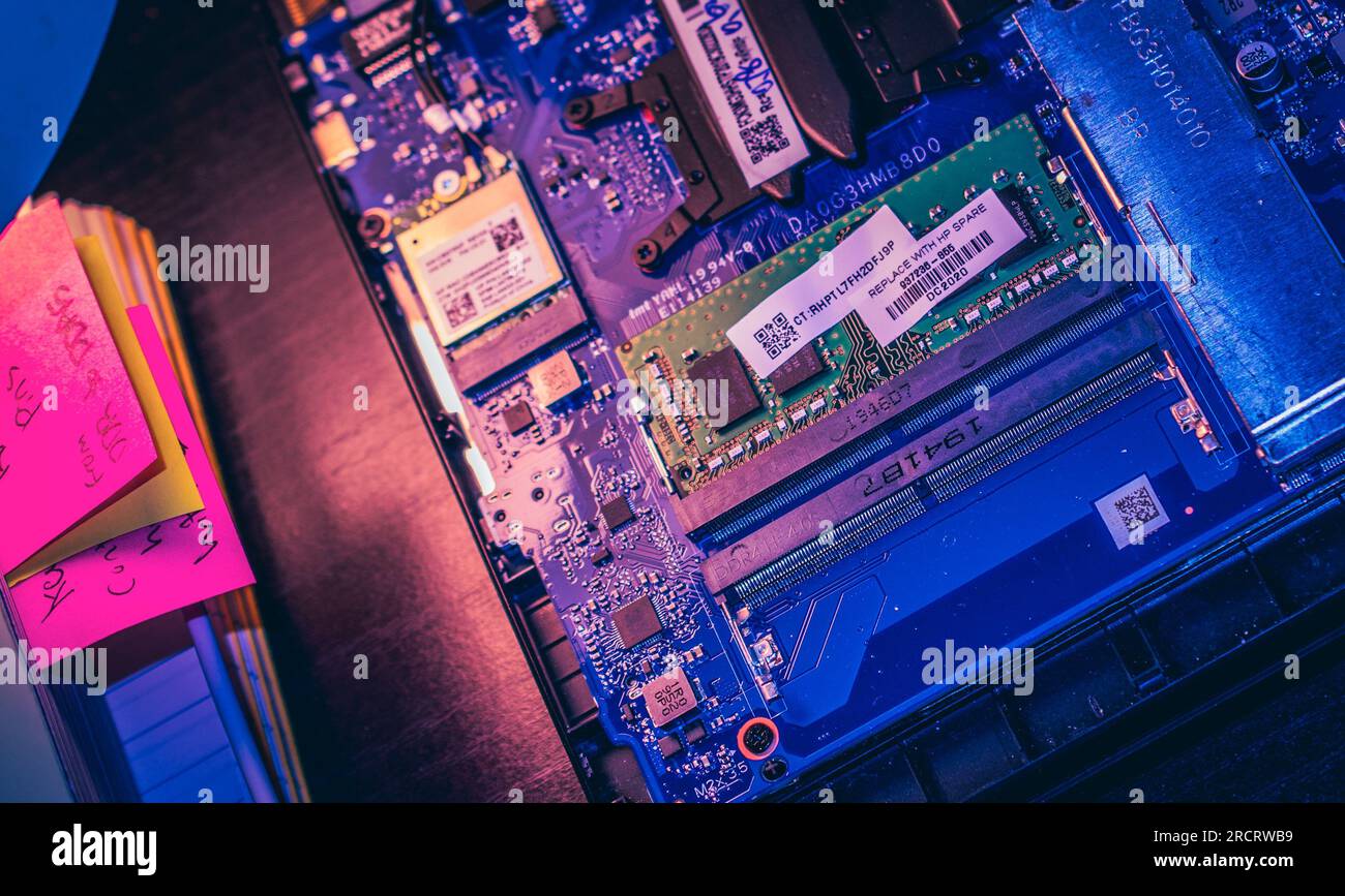 Laptop motherboard with sticky notes on the side placed on a desk with ...