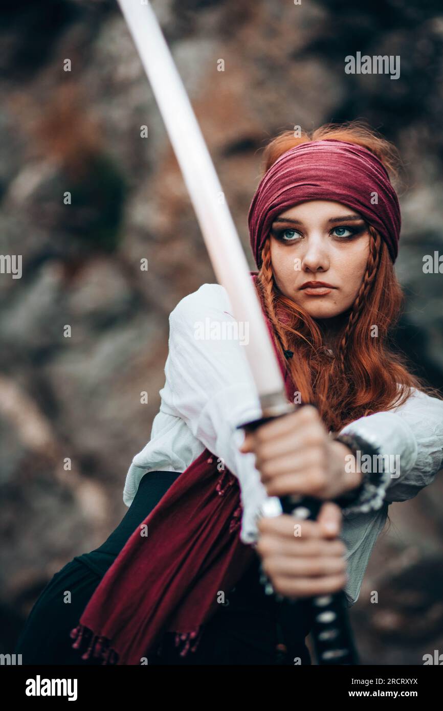Outdoor portrait of young female in pirate costume with a sword Stock ...