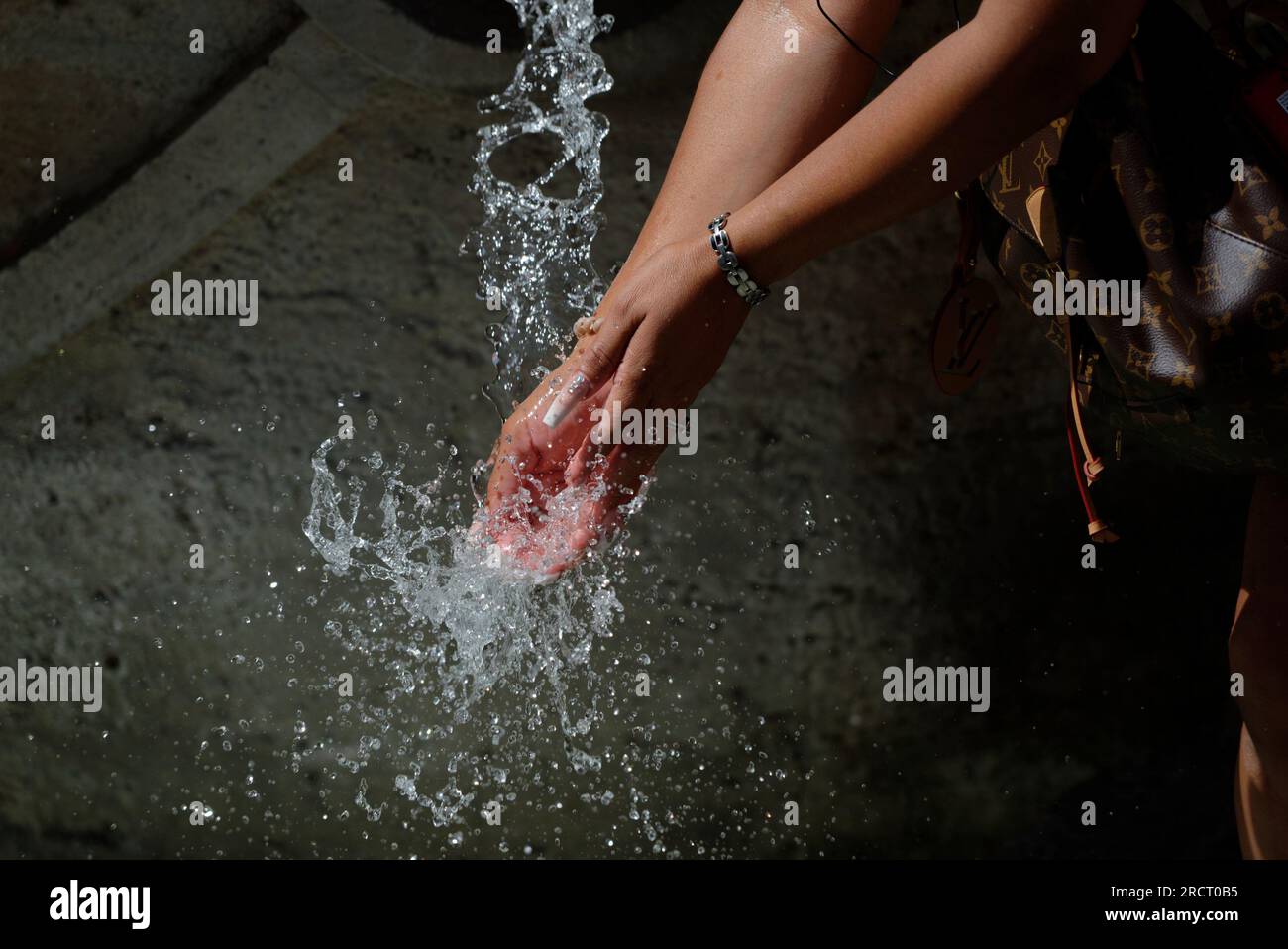 People cool off during an ongoing heat wave with temperatures reaching ...