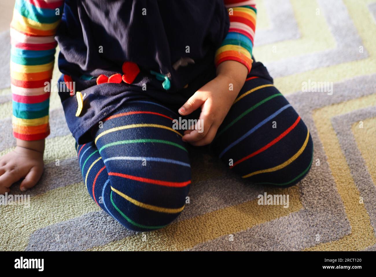 child sitting W posture on the floor Stock Photo - Alamy