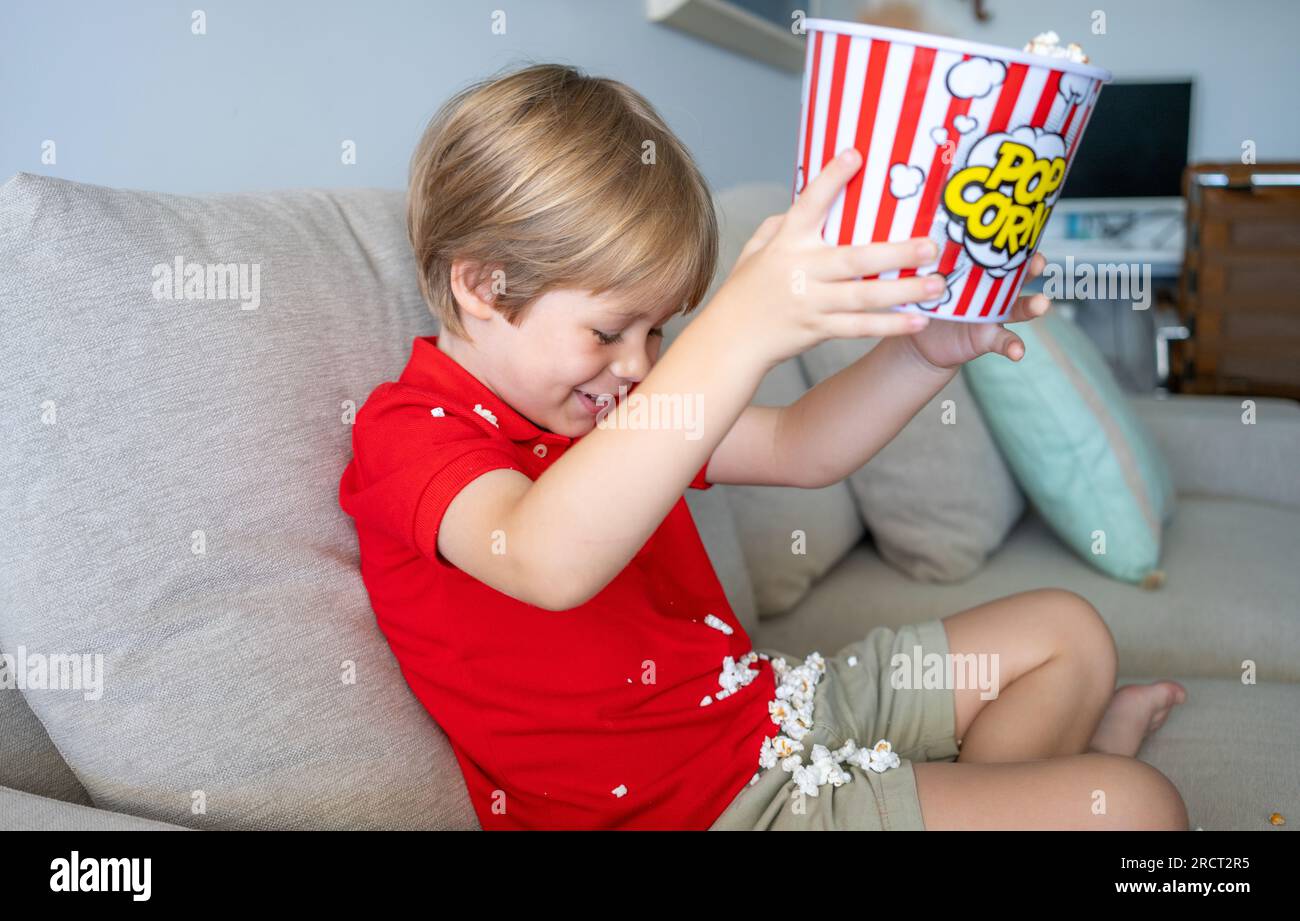 young boy eating popcorn and sharing from a bowl Stock Photo - Alamy