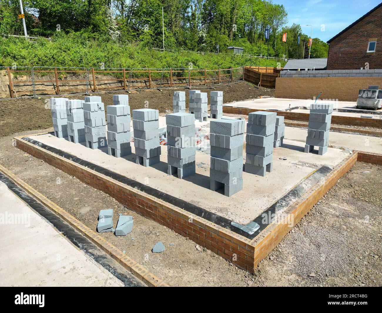 Pontypridd, Wales, UK - 20 May 2023: Stacks of concrete blocks on the foundation for a new house ...