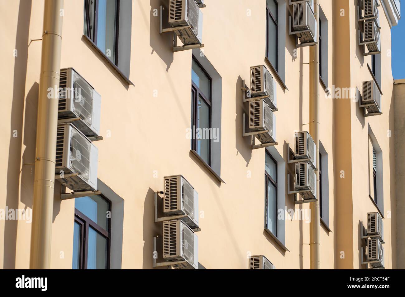 Facade of building with many air conditioners on windows in southern ...