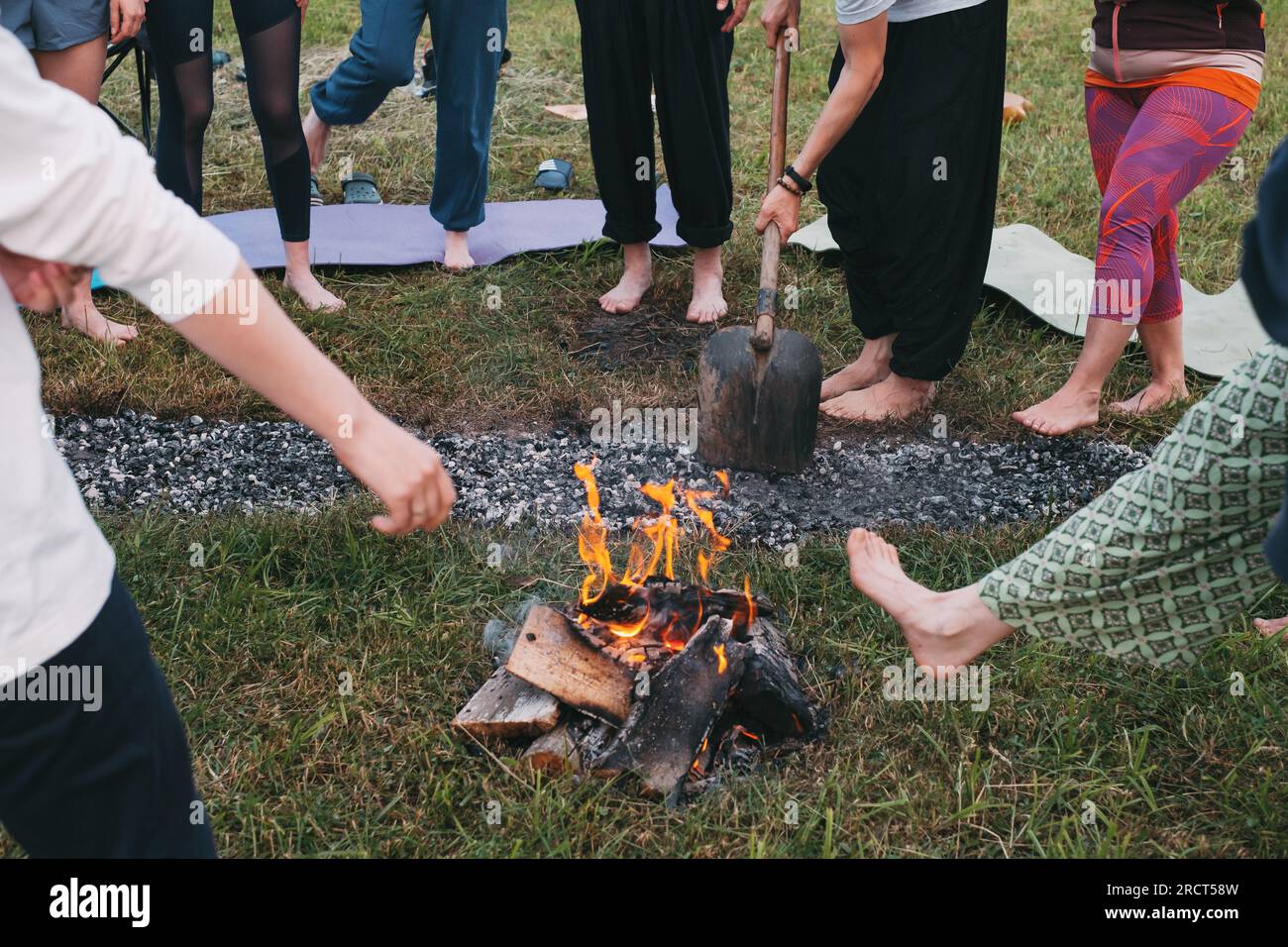 Coal walking or fire walking. Barefoot person on burned wood and hot ...