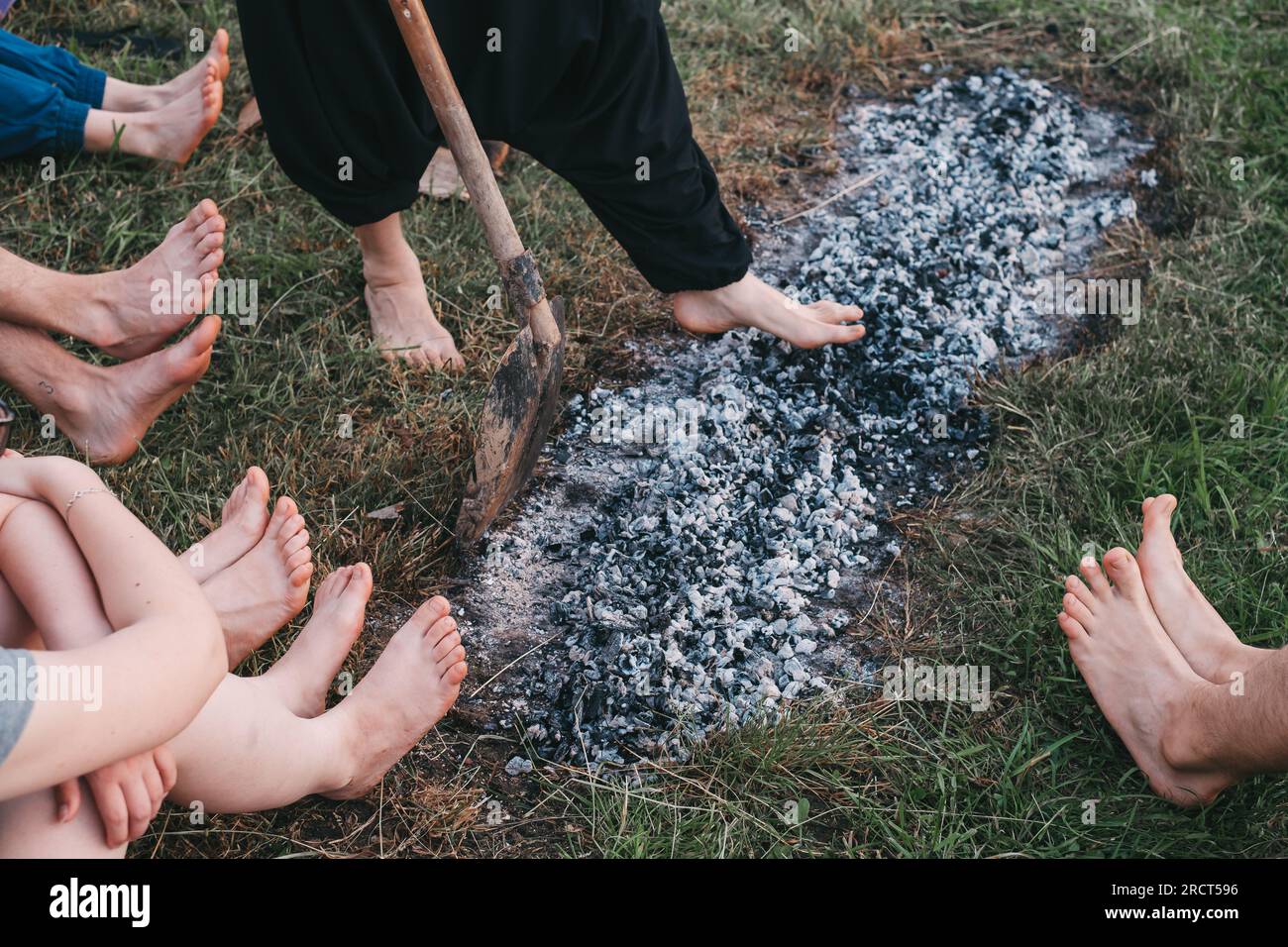 Coal walking or fire walking. Barefoot person on burned wood and hot ...