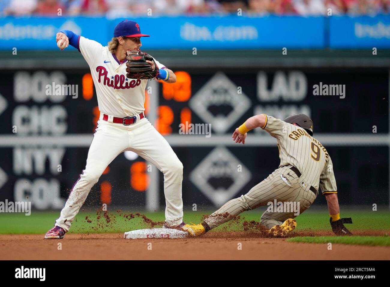 Philadelphia Phillies second baseman Bryson Stott, left, throws to first after forcing out San ...