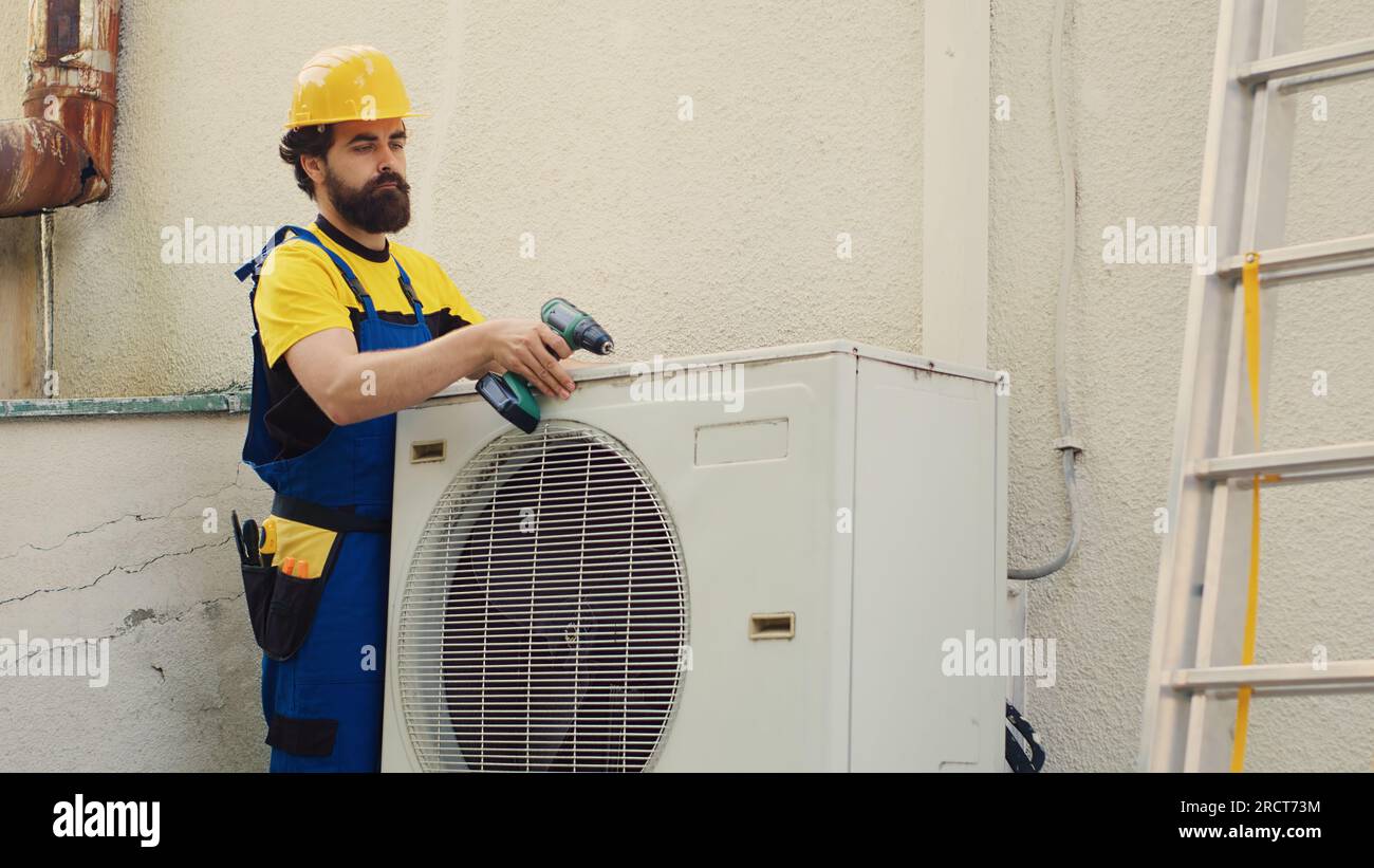 Knowleadgeable engineer dissasembling external air conditioner metal ... Knowleadgeable engineer dissasembling external air conditioner metal ...