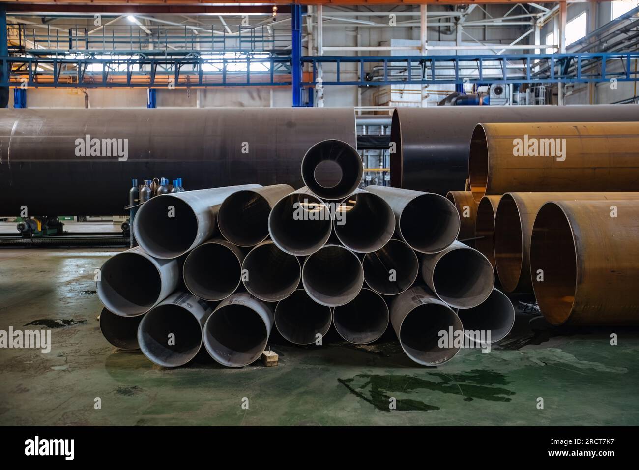 New steel pipes for pipeline construction in warehouse Stock Photo - Alamy