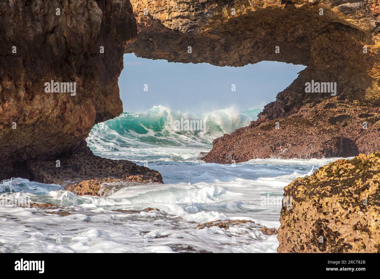 Emerald wave going through the rocks of Siung beach at Java coast Stock ...