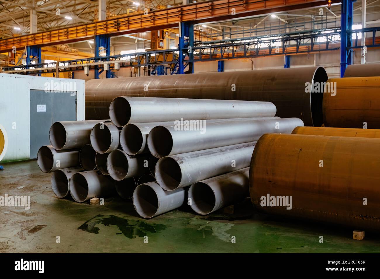New steel pipes for pipeline construction in warehouse Stock Photo - Alamy