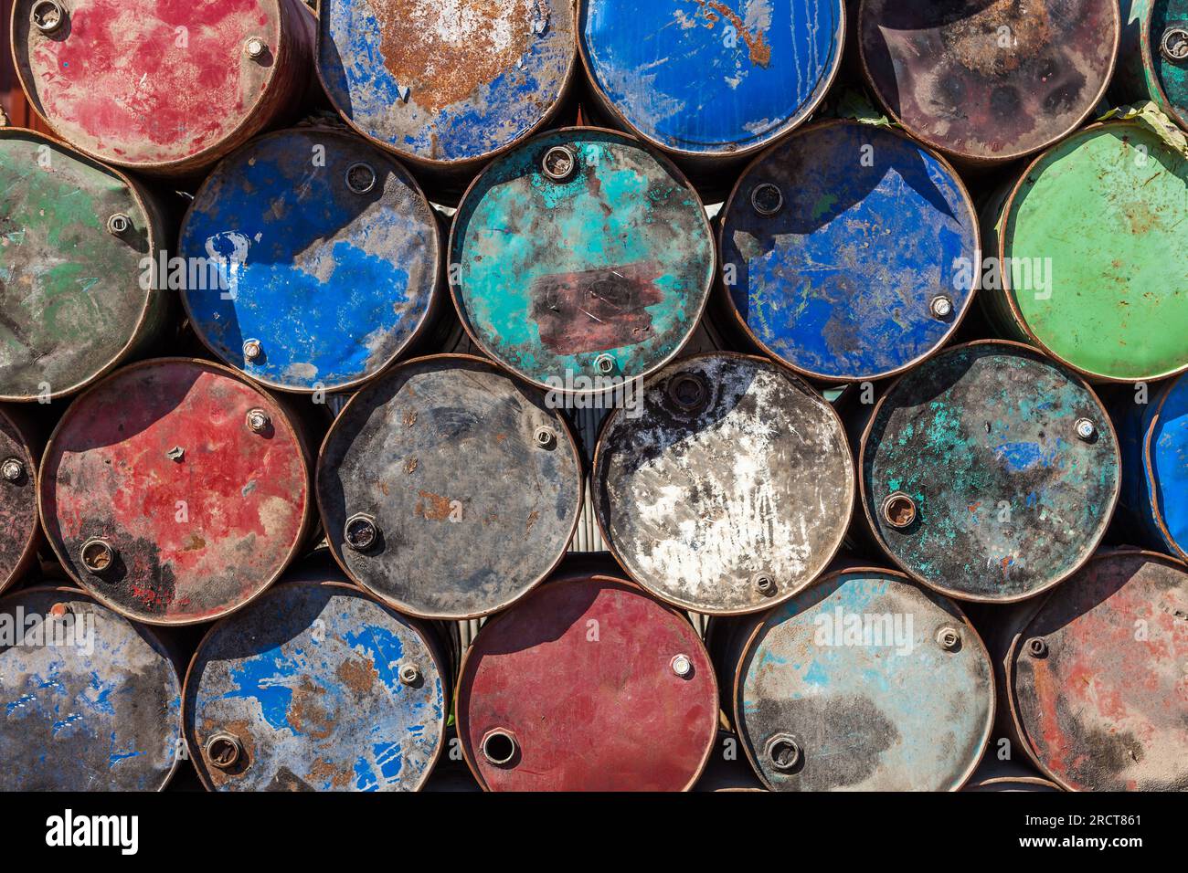 Old fuel tanks. Stacked rusty barrels. Old oil cans background. Ecology ...