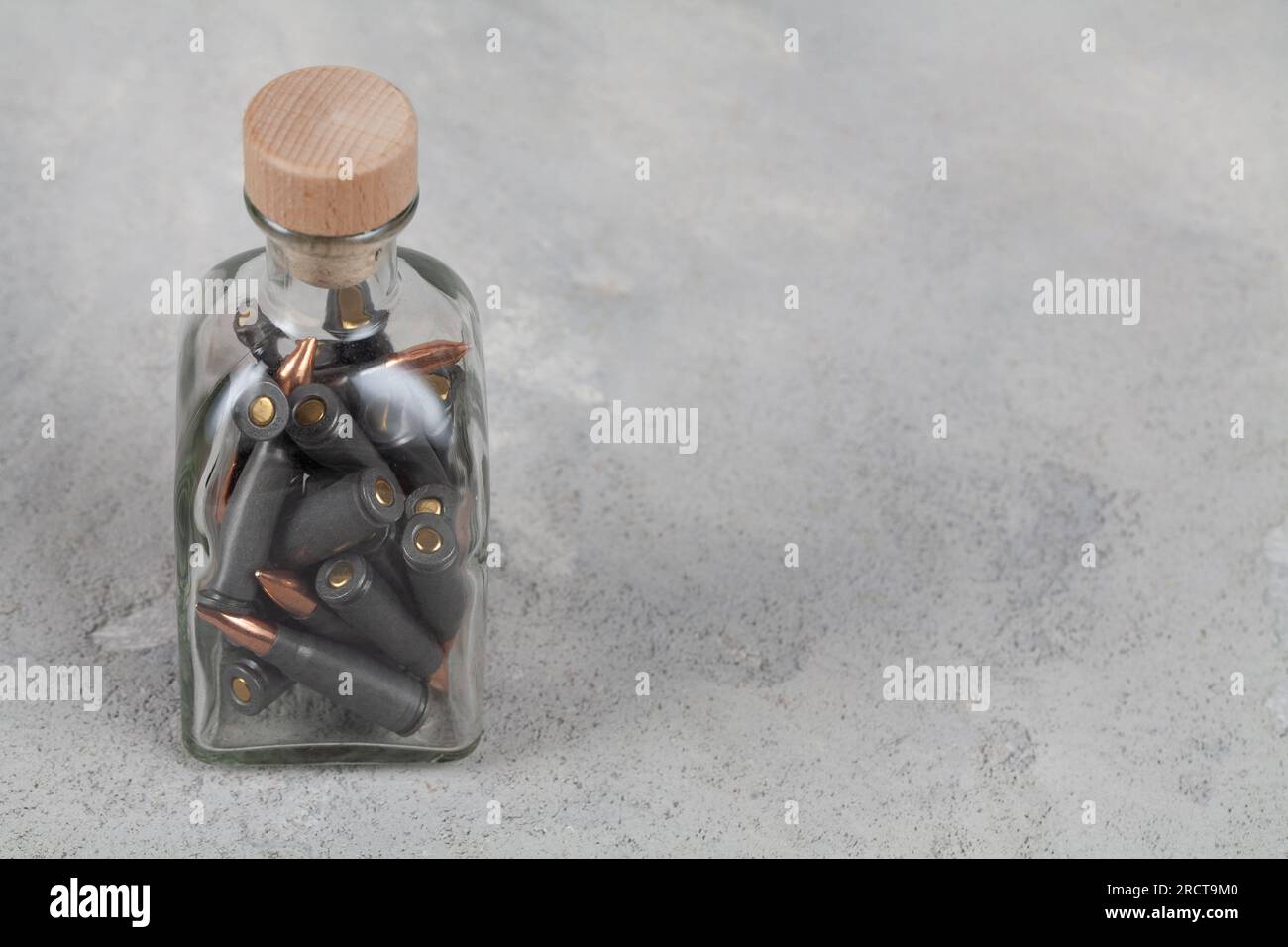 kalashnikov 7.62mm bullets in a spice jar on grey concrete surface ...