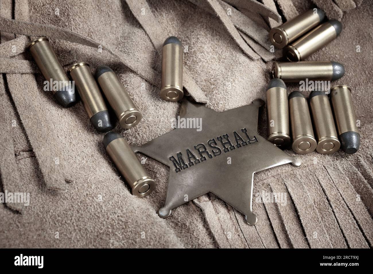 Old west marshal badge with ammunition background Stock Photo - Alamy