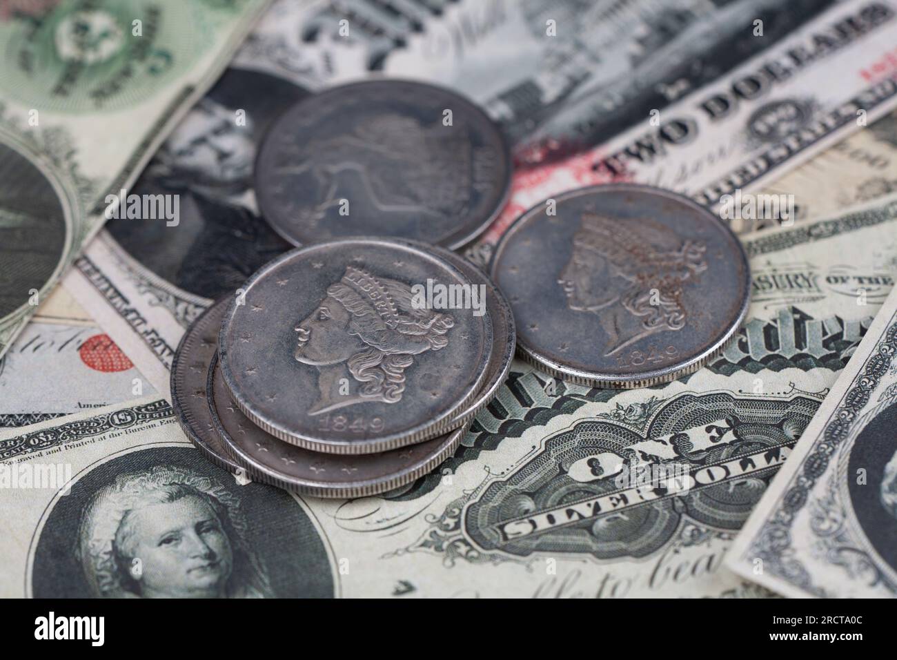 Old west US banknotes and silver certificates with silver dollar coins ...