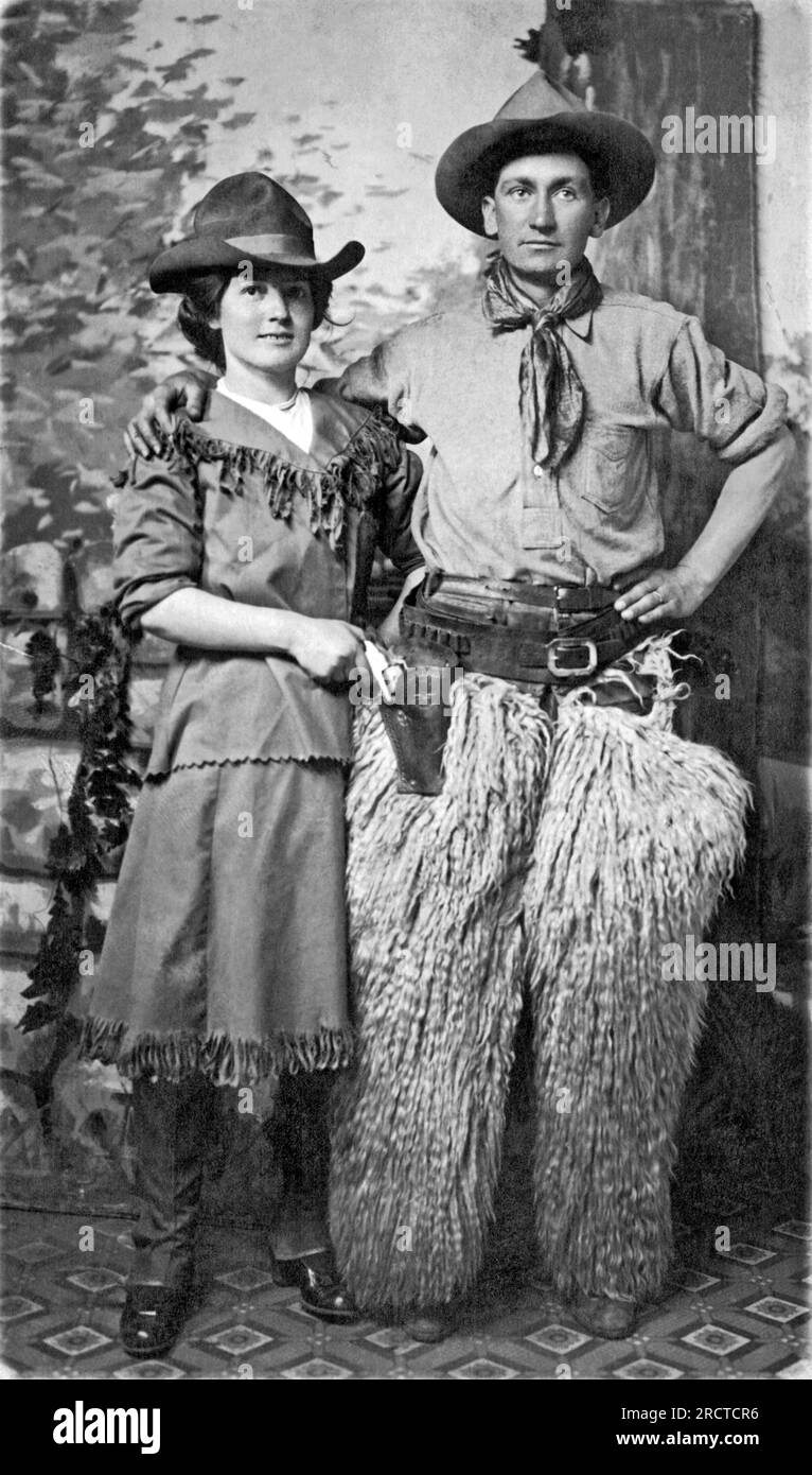 United States: c. 1900. A couple pose for a studio portrait in Western ...