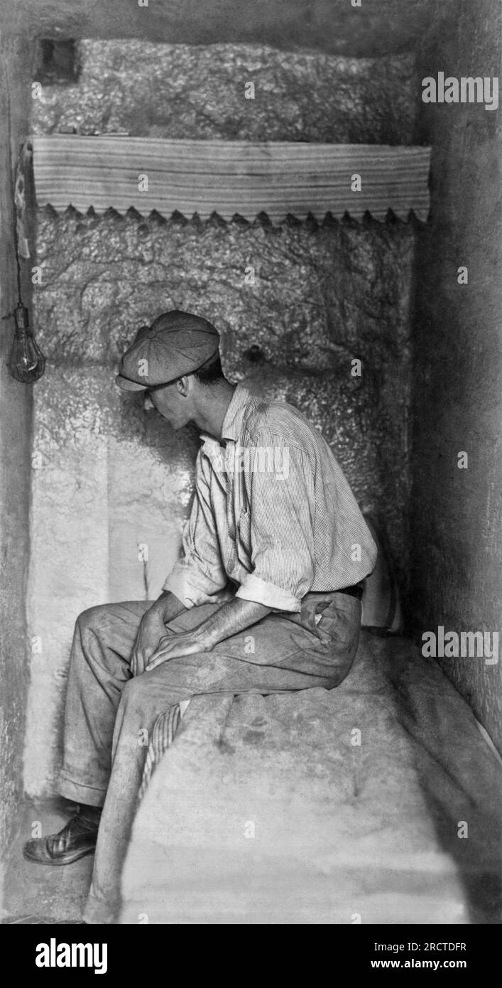 Ossining, New York: 1936. A prisoner in his cell at the 110 year old ...