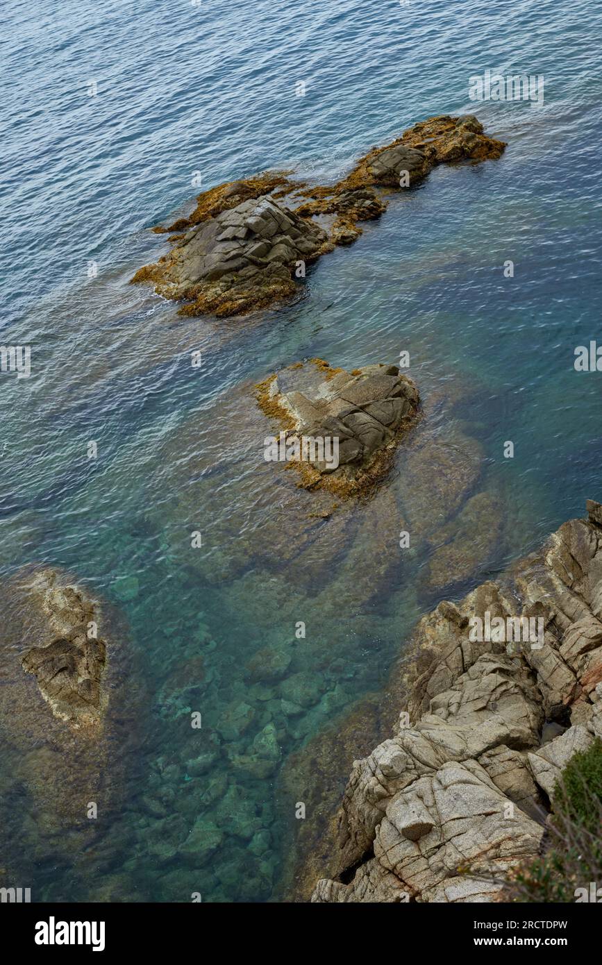 Rocks in the water. Top view dark blue sea water wave in the sea. Top ...