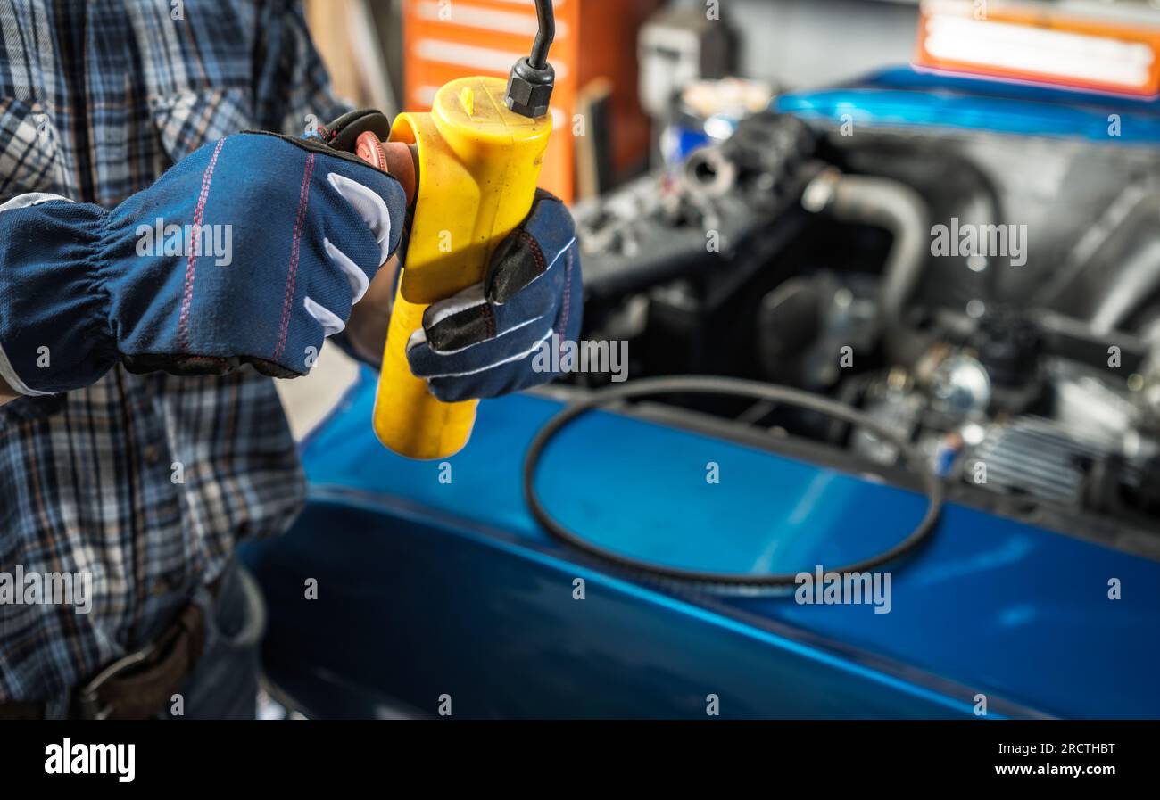 Car Mechanic Using Powerful Repair Shop Engine Lift Remote. Automotive ...