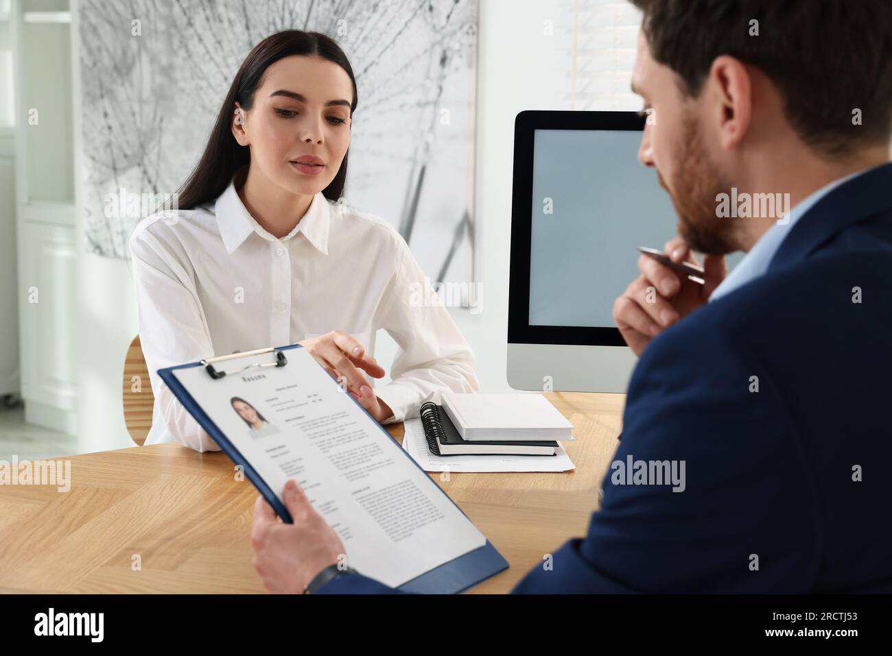 Human resources manager reading applicant's resume in office Stock Photo - Alamy